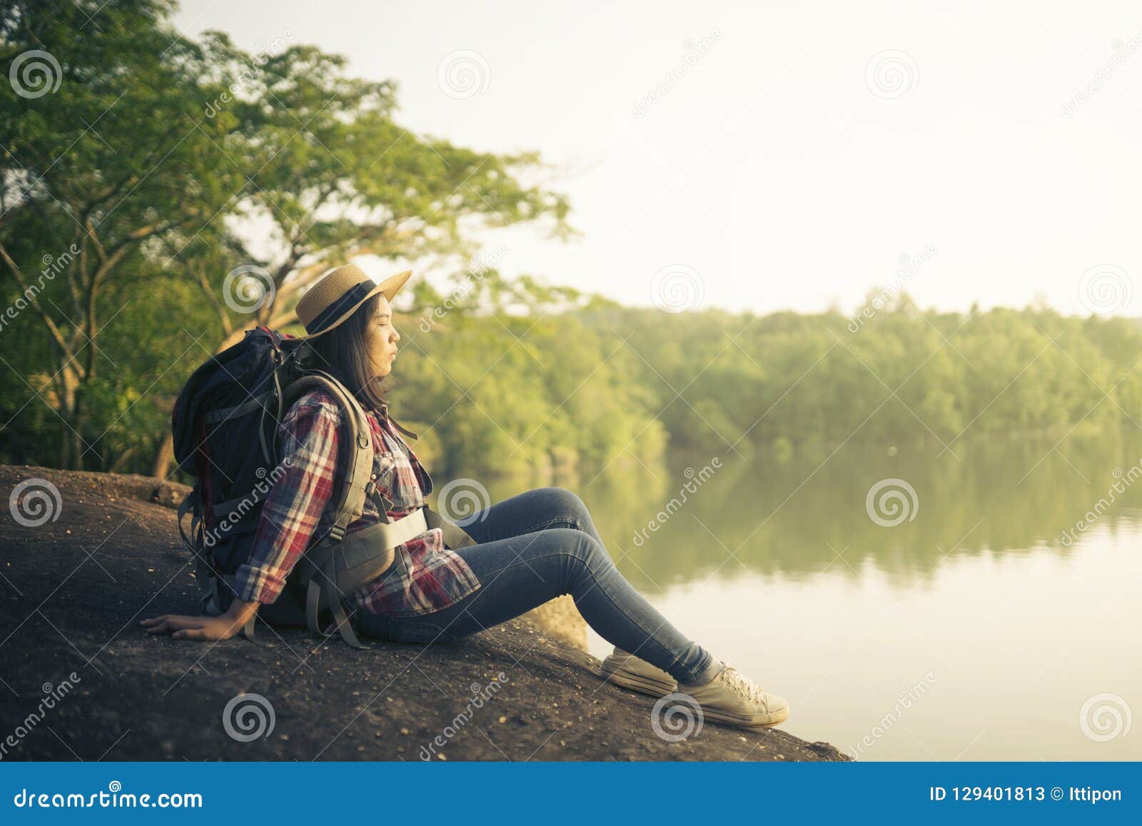Backpacker woman sitting stock image. Image of hill - 129401813