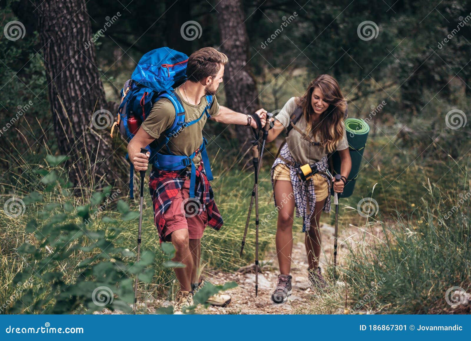 Backpackers Couple Hiking during Fall with Sticks Stock Image - Image ...
