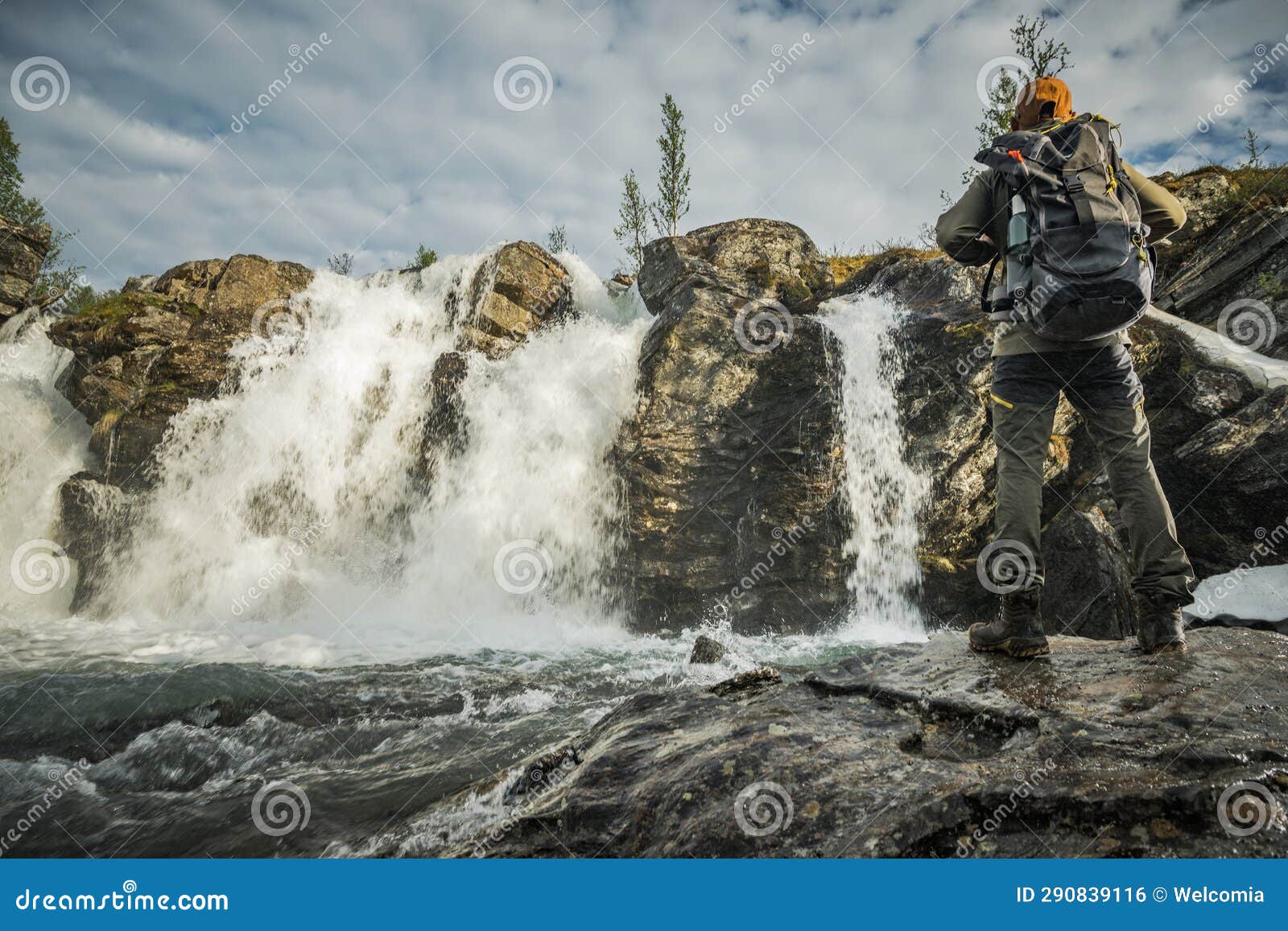 Backpacking Hiker in Front of a Scenic Waterfall Stock Photo - Image of ...