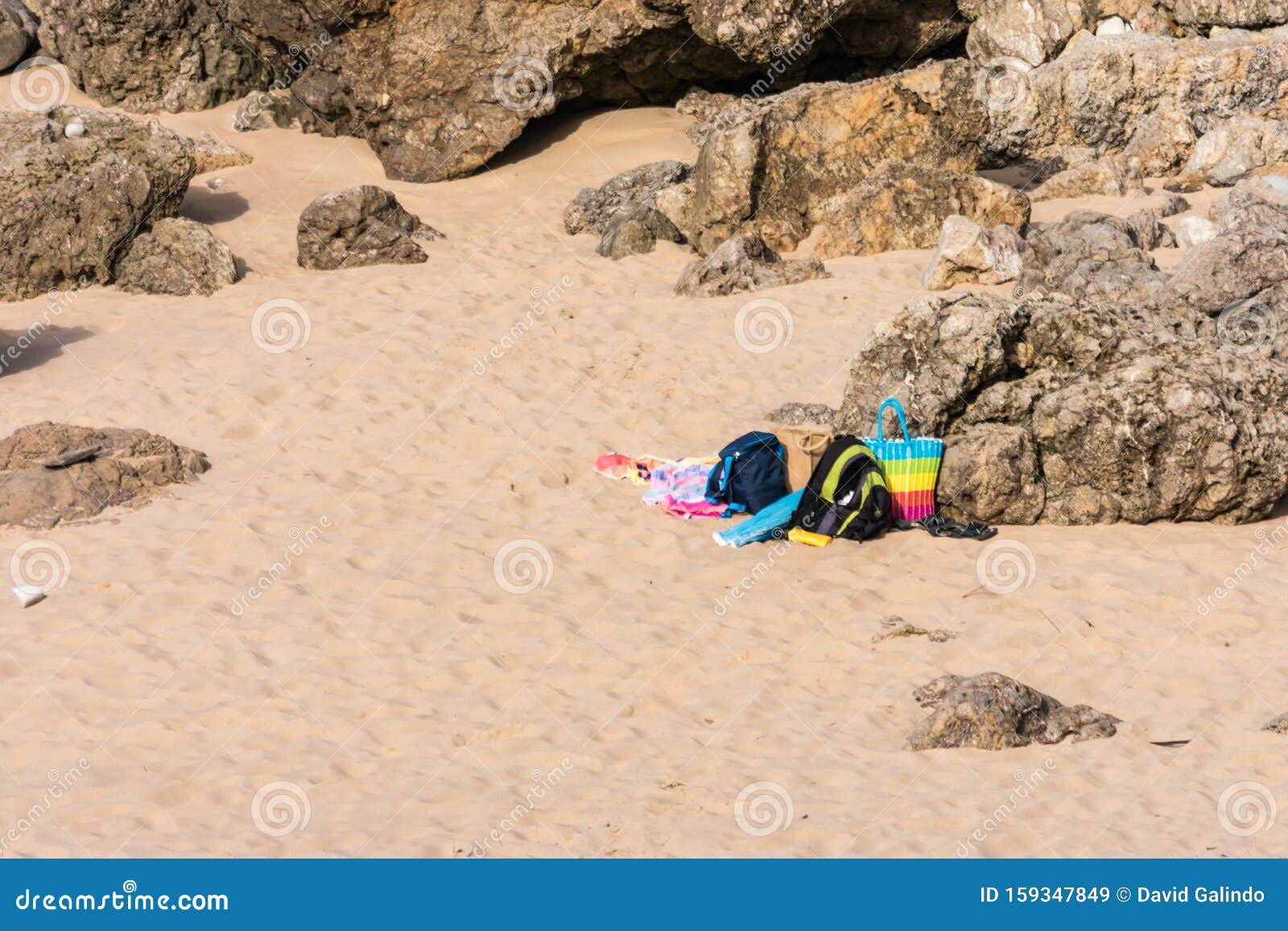 Backpacks and Bags Resting on the Rock on the Beach Sand Stock Image ...