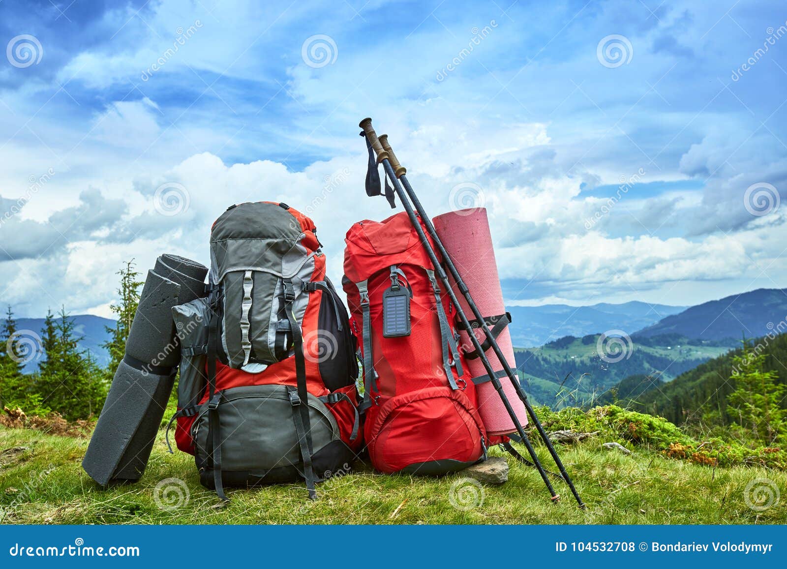 Backpacks in the Mountains Overlooking the Mountains on the Green Grass ...