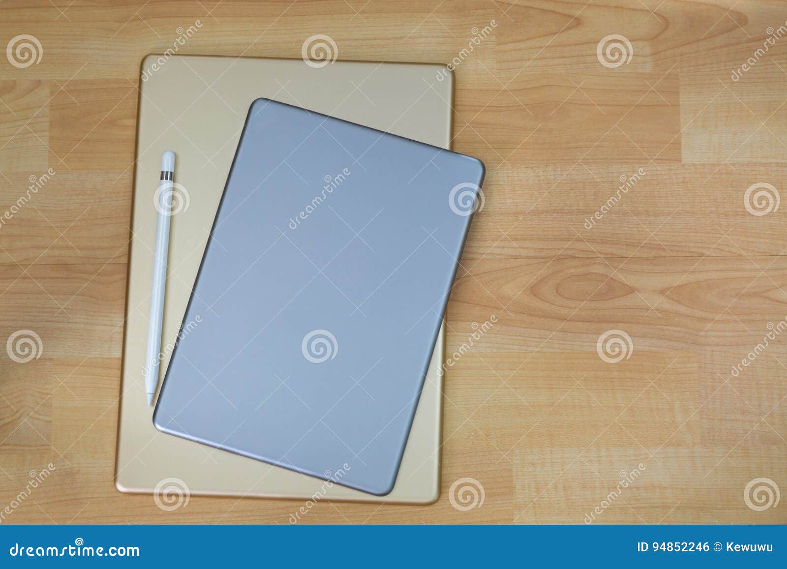 Backside of Gold Silver Pro Tablet Computer Next To White Pencil Stock ...