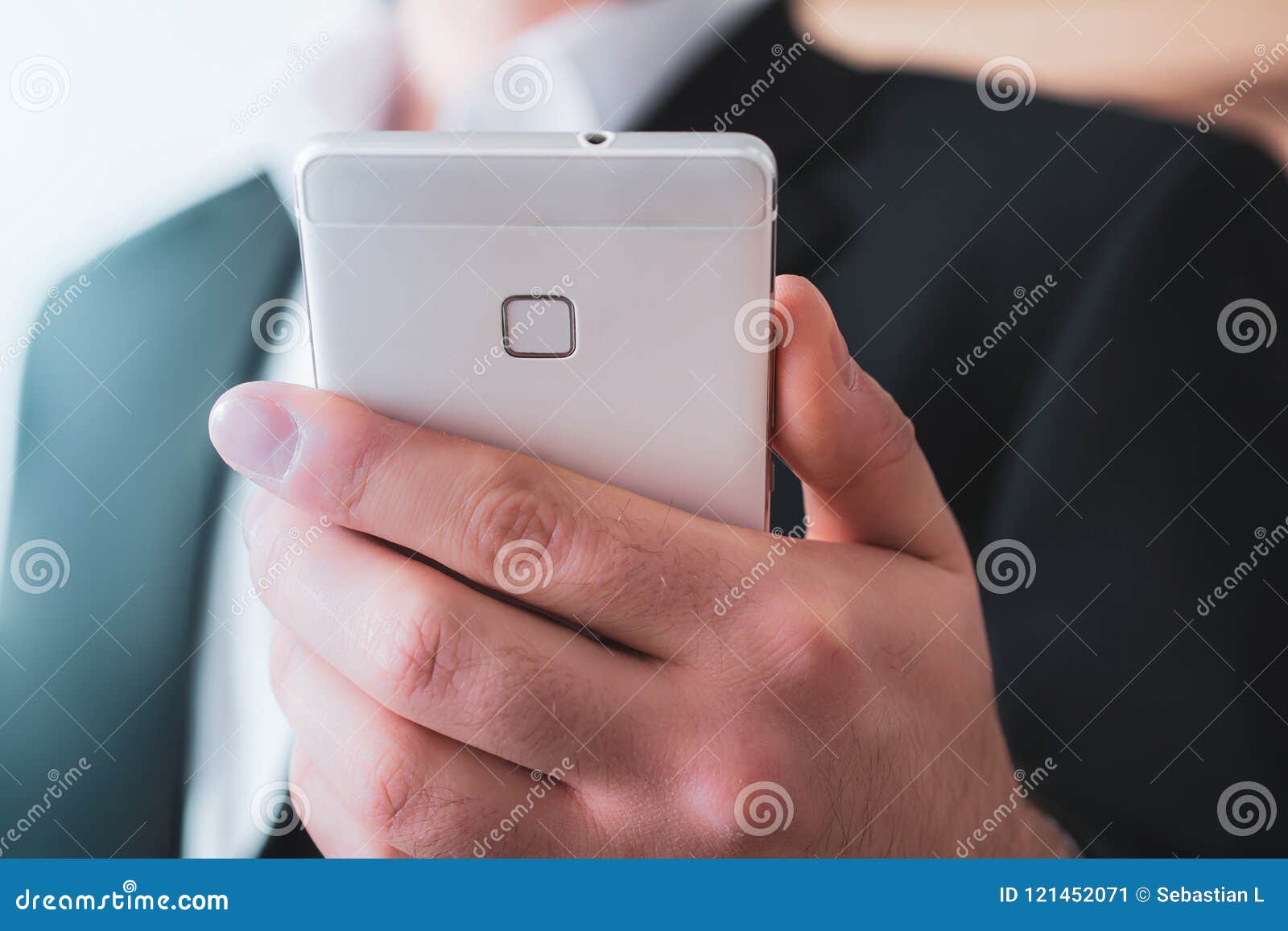 Backside of a Smartphone, Holded by the Hand of a Businessman in Suit ...