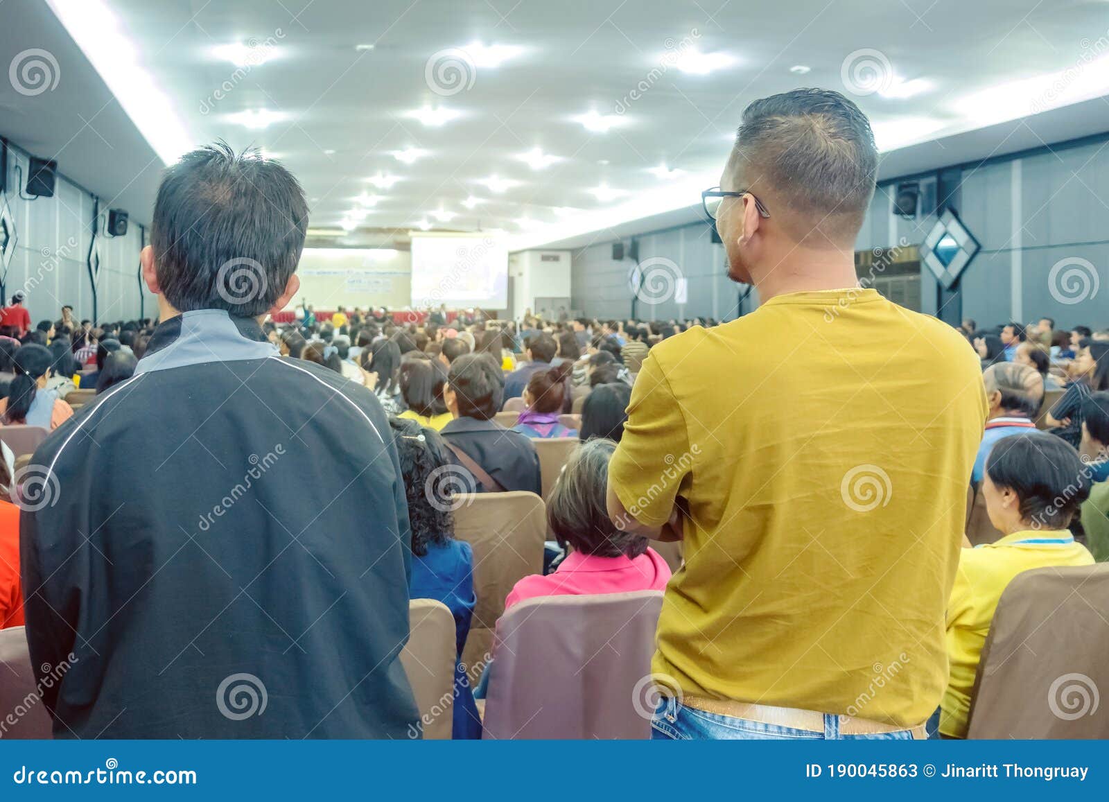 Backside View of Spectators Standing in a Gathering in the Back of ...