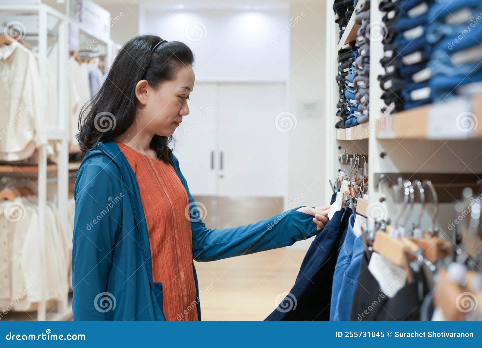 Backside of a Woman Wearing without Face Mask Was Selecting Navy Pants ... Backside of a Woman Wearing without Face Mask Was Selecting Navy Pants ...