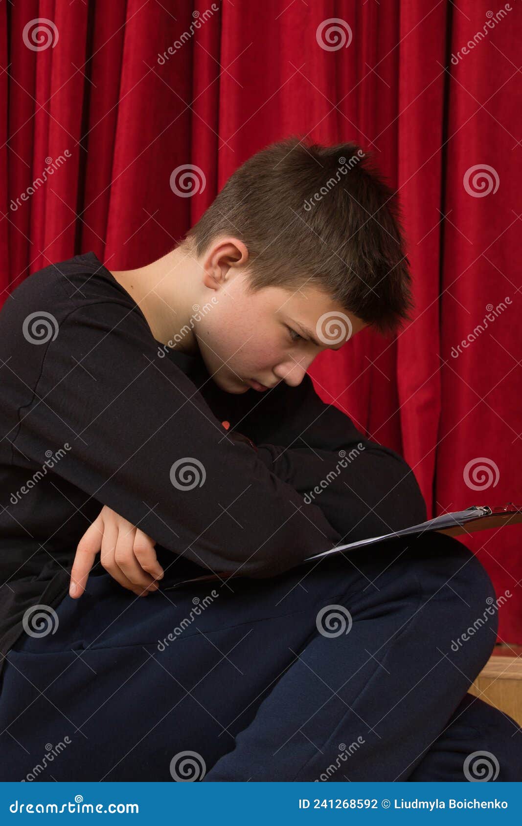 Backstage at the Stage, a Young Actor is Carefully Studying His Script ...