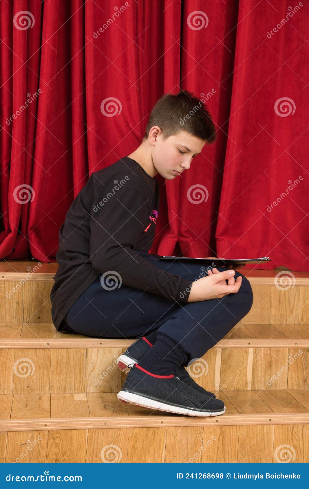 Backstage at the Stage, a Young Actor is Carefully Studying His Script ...