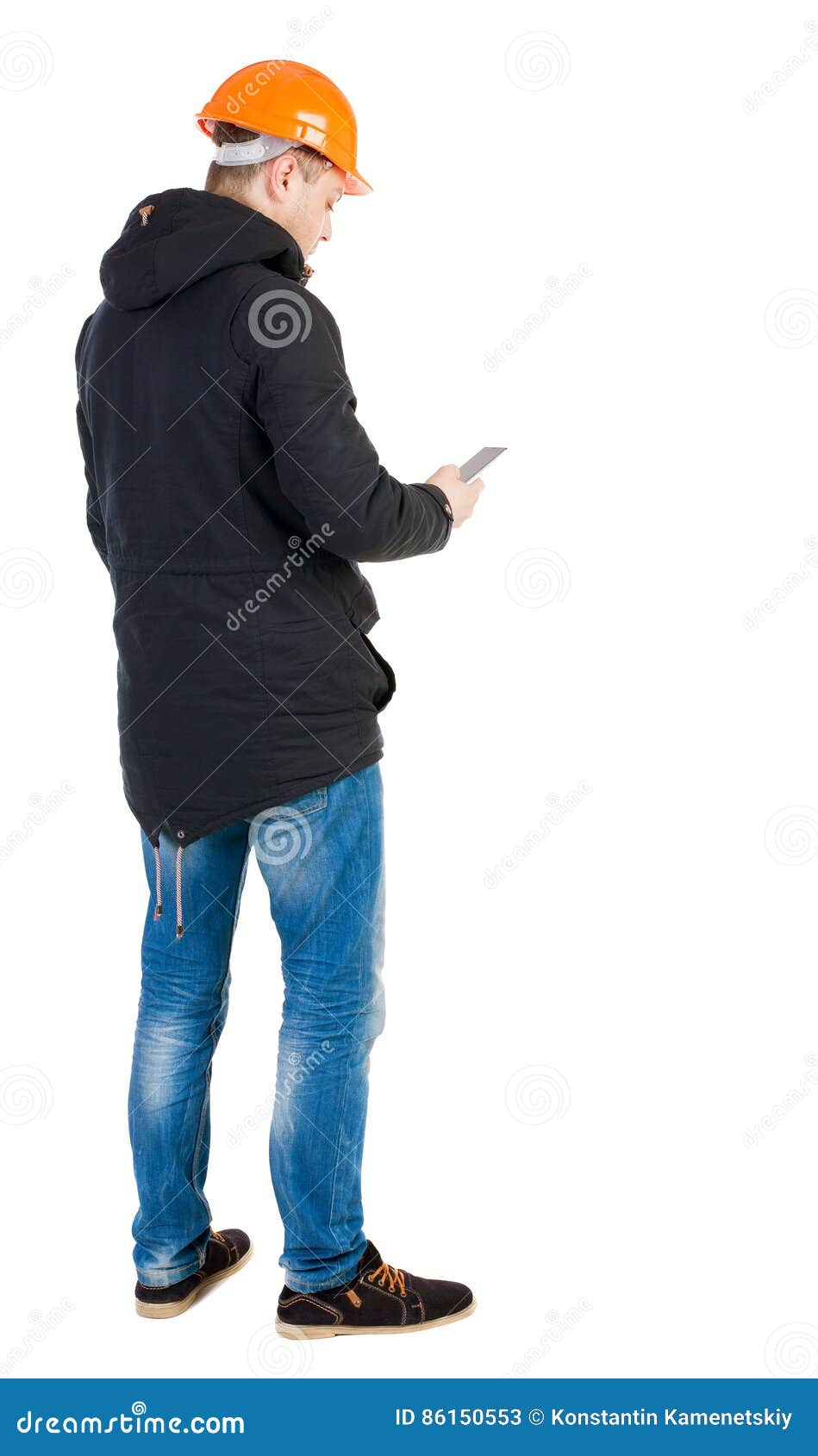 Backview of an Engineer in Construction Helmet Stands and Using Stock ...