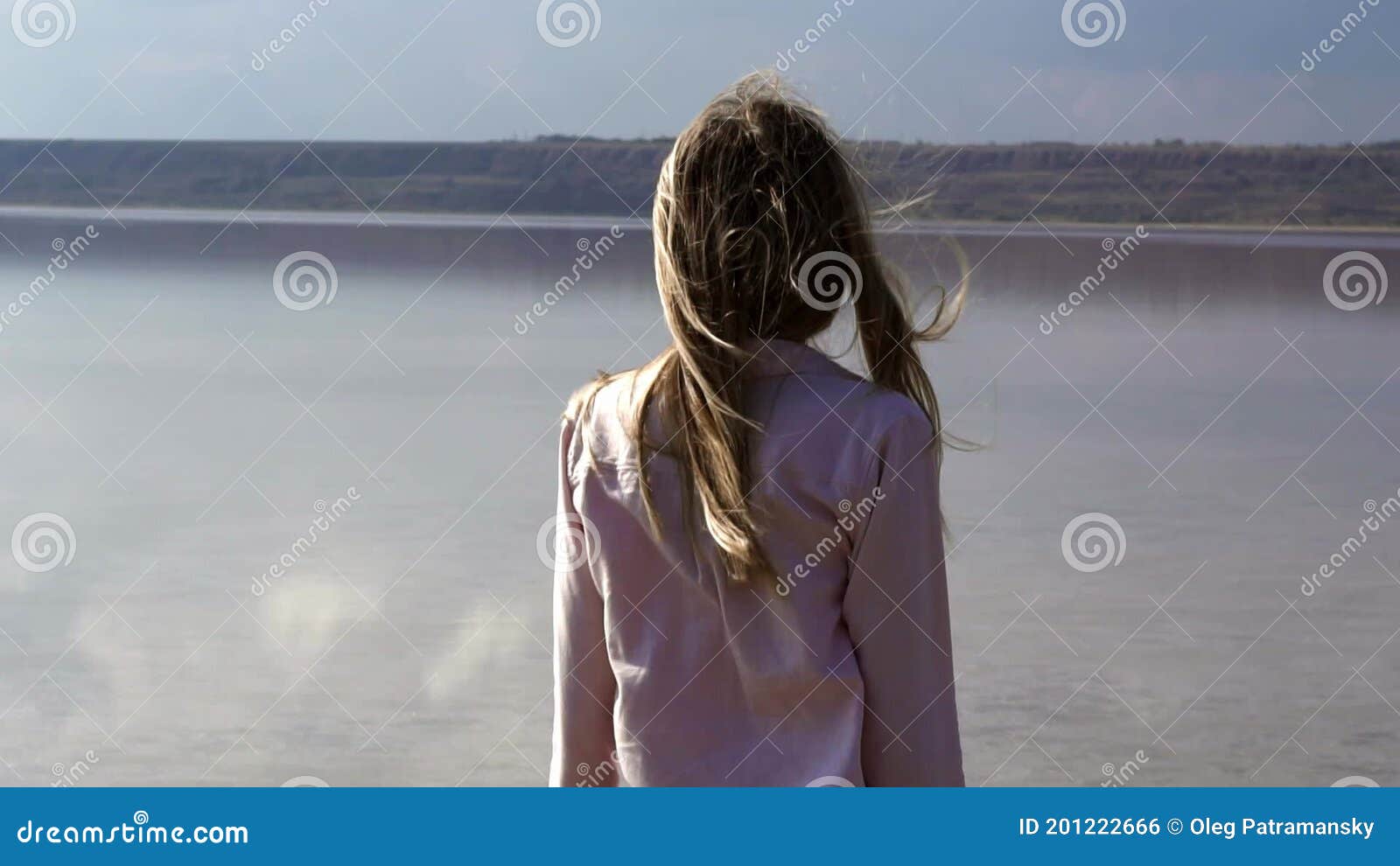 Backview of Long Haired Woman Facing River with Wind Blowing Stock ...