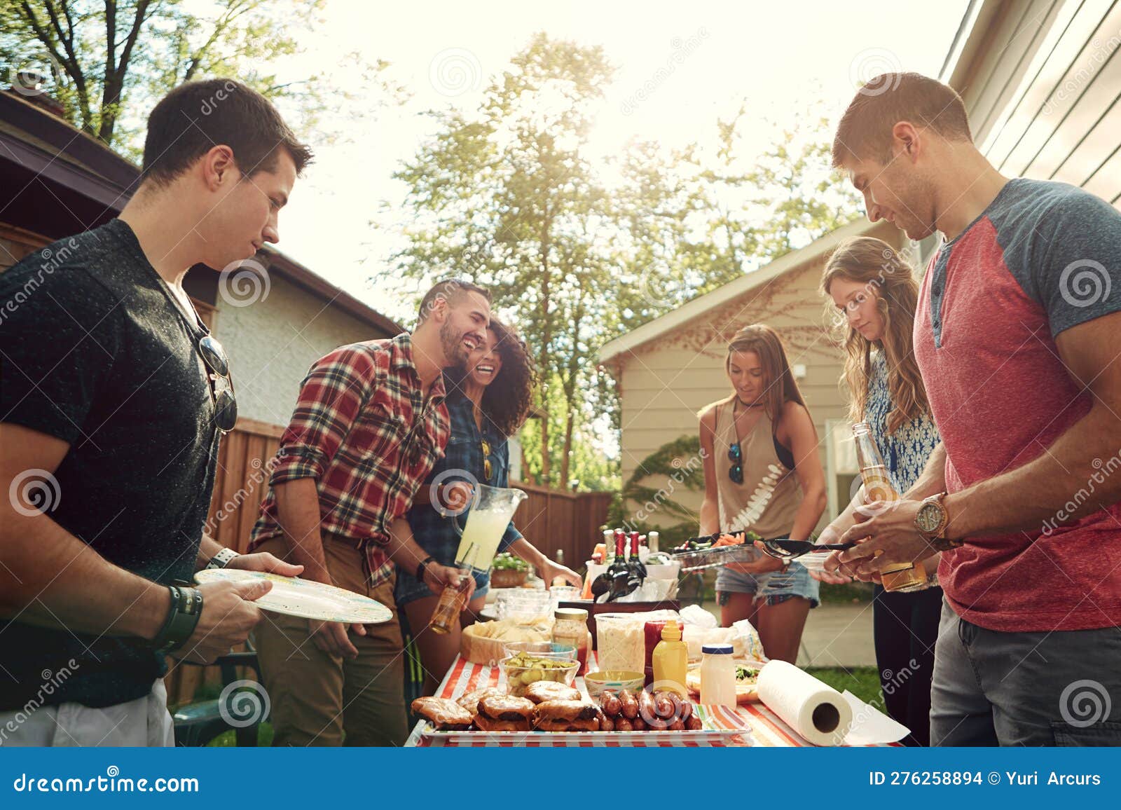 Backyard Barbecue with Buddies. a Group of Friends Having Lunch in ...