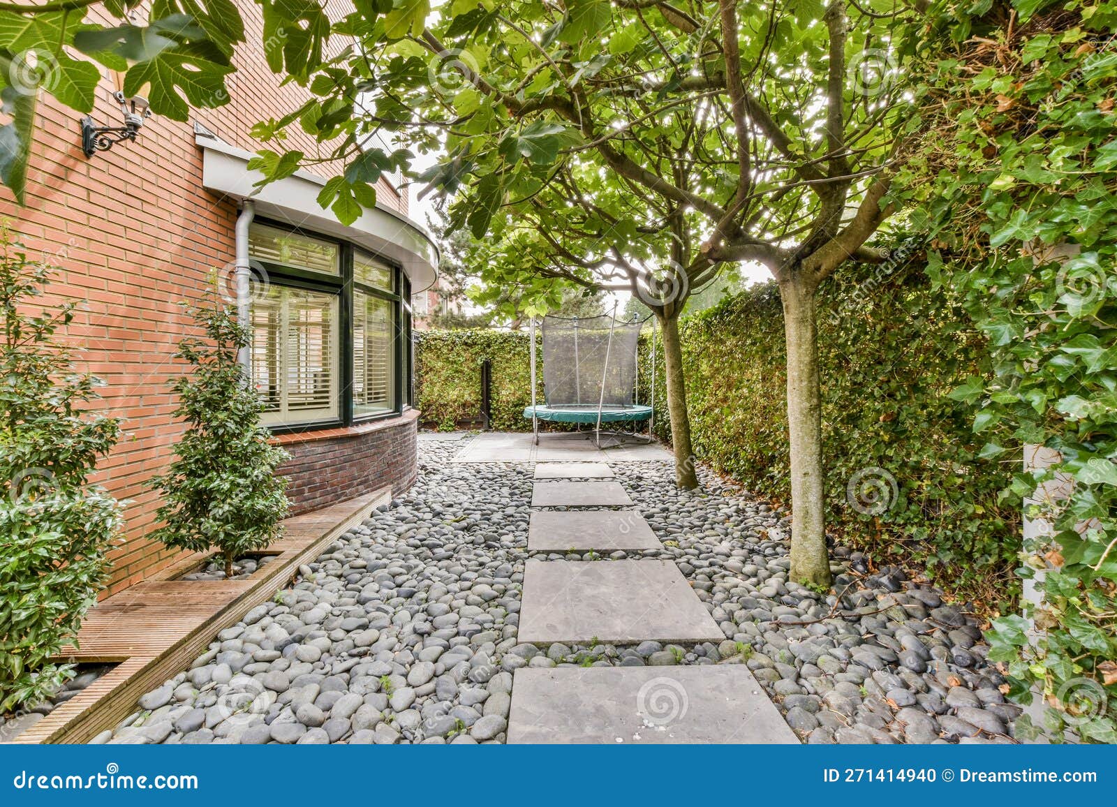 A Backyard with a Bench and Trees and a Stone Editorial Image - Image ...