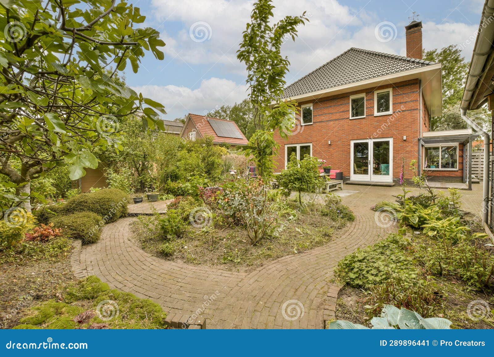 A Backyard with a Brick Path and a House Stock Image - Image of brick ...