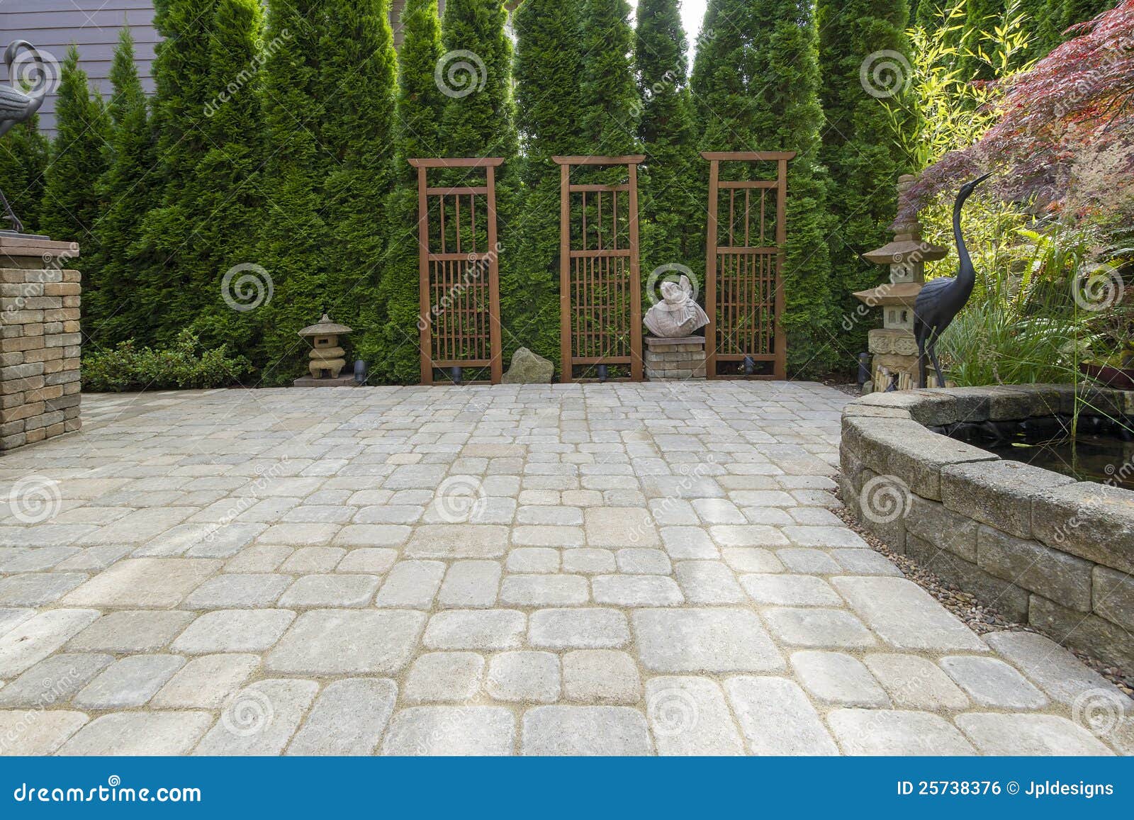 Backyard Paver Patio with Pond in Garden Stock Photo - Image of plants ...