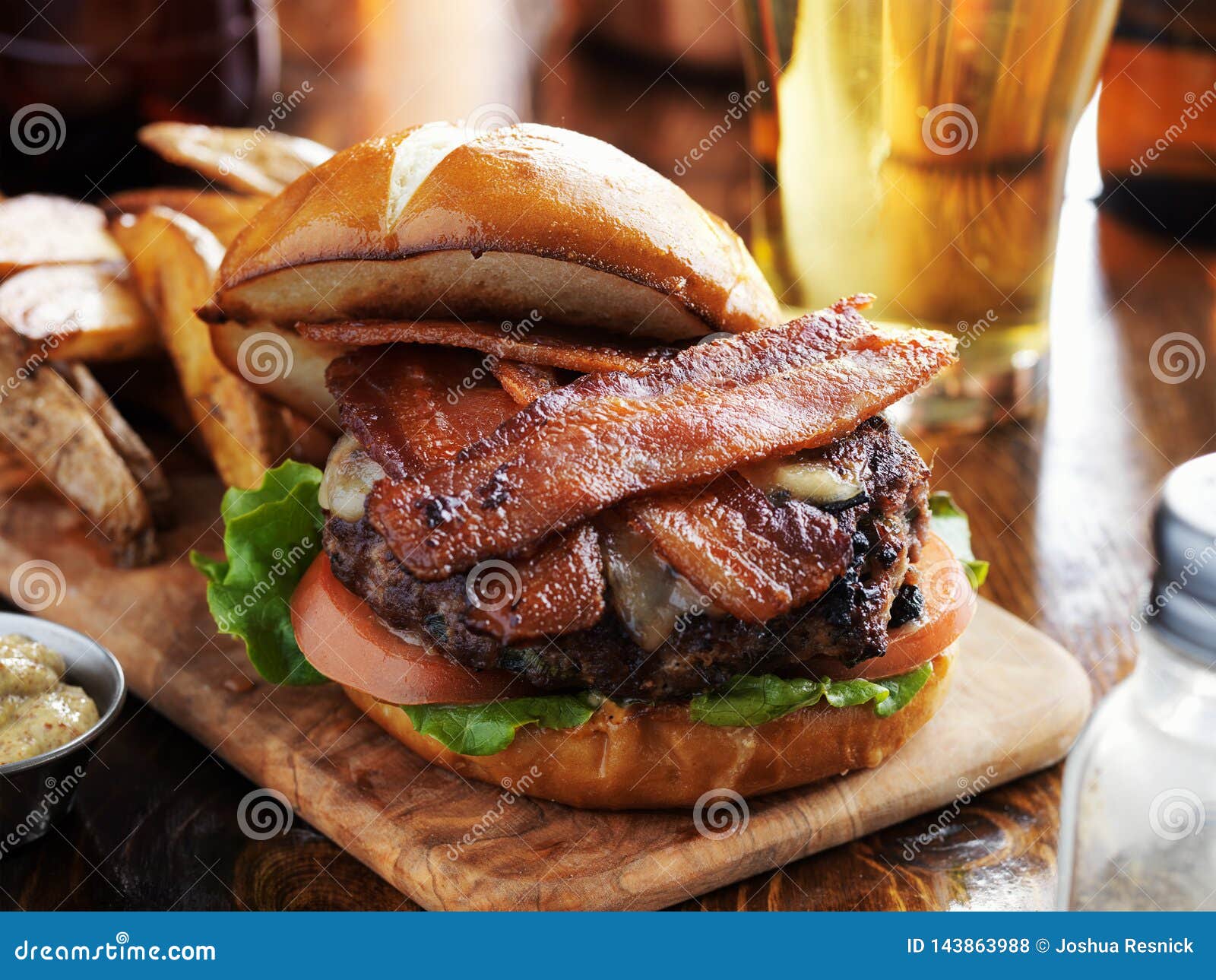 Bacon Burger with Pretzel Bun and Beer Stock Photo - Image of ...