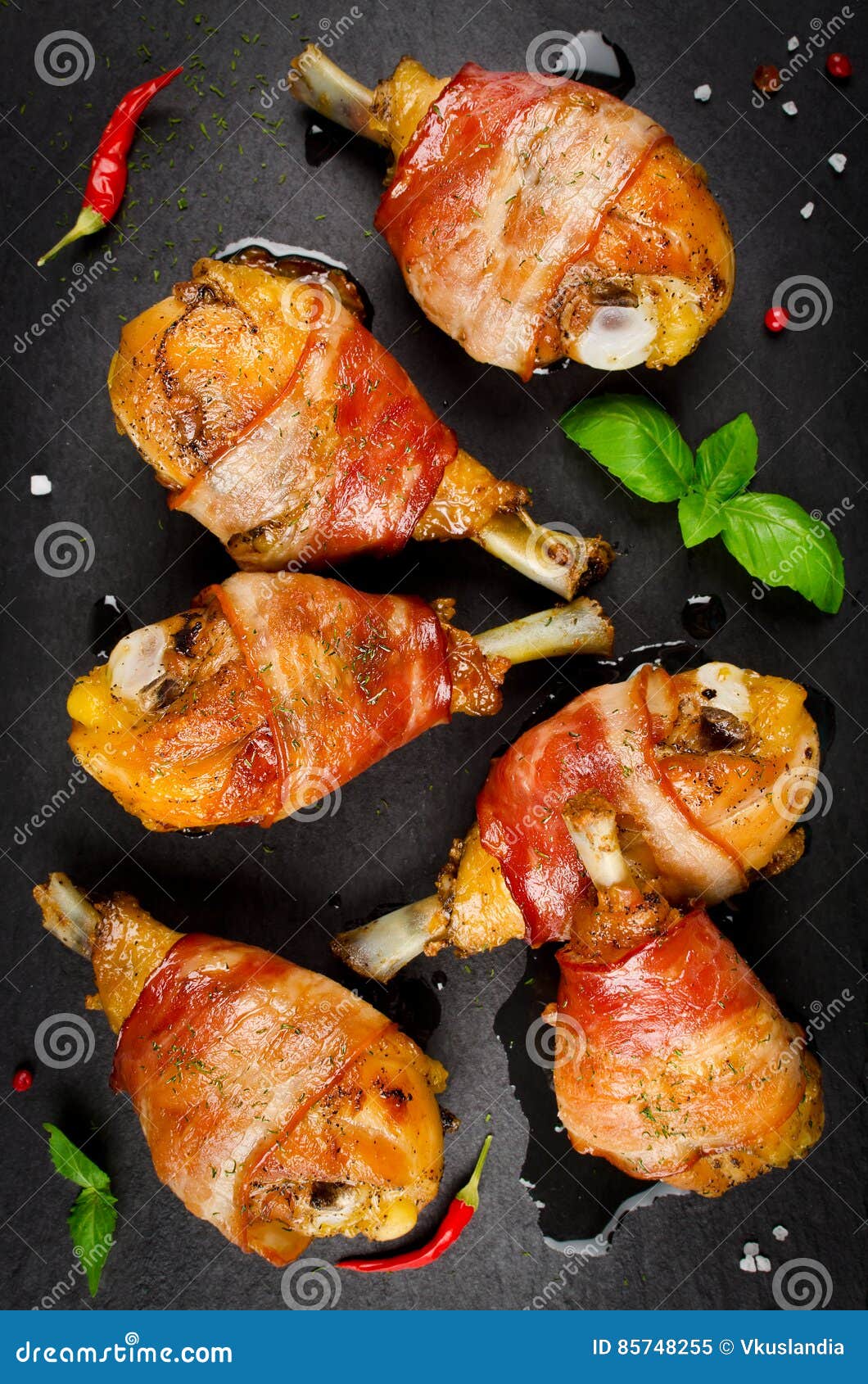 Bacon Wrapped Chicken Legs on a Black Background Stock Image - Image of ...