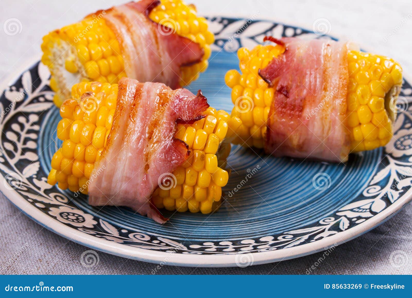 Bacon Wrapped Corn on Blue Plate. Stock Image - Image of canned, clean ...