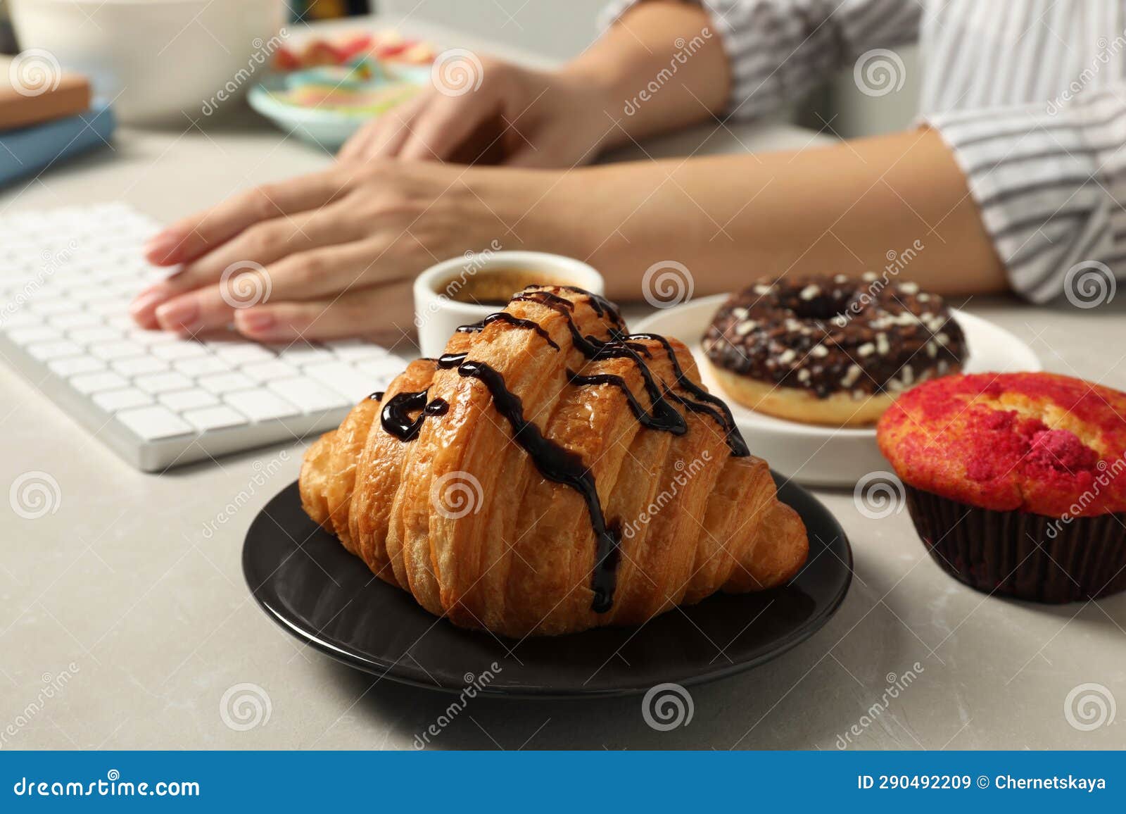 Bad Eating Habits. Woman Working on Computer at Light Grey Marble Table ...