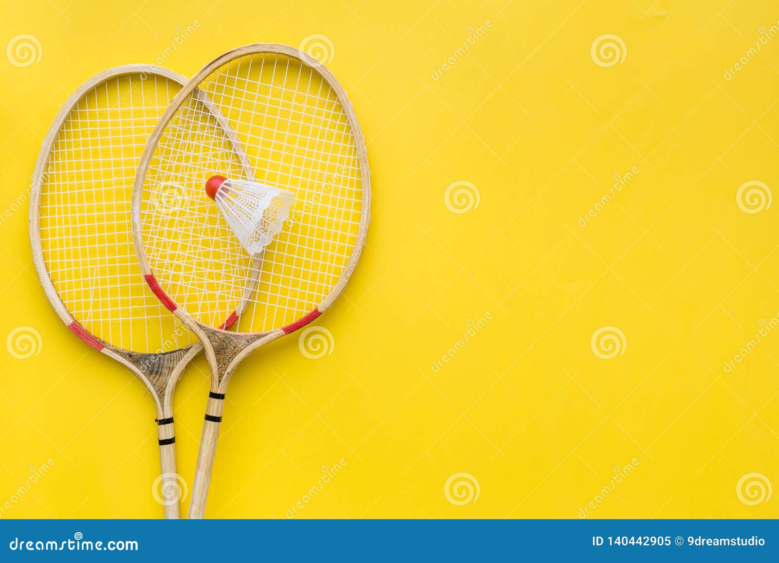 Badminton Concept. Badminton Rackets and Shuttlecock on Yellow ...