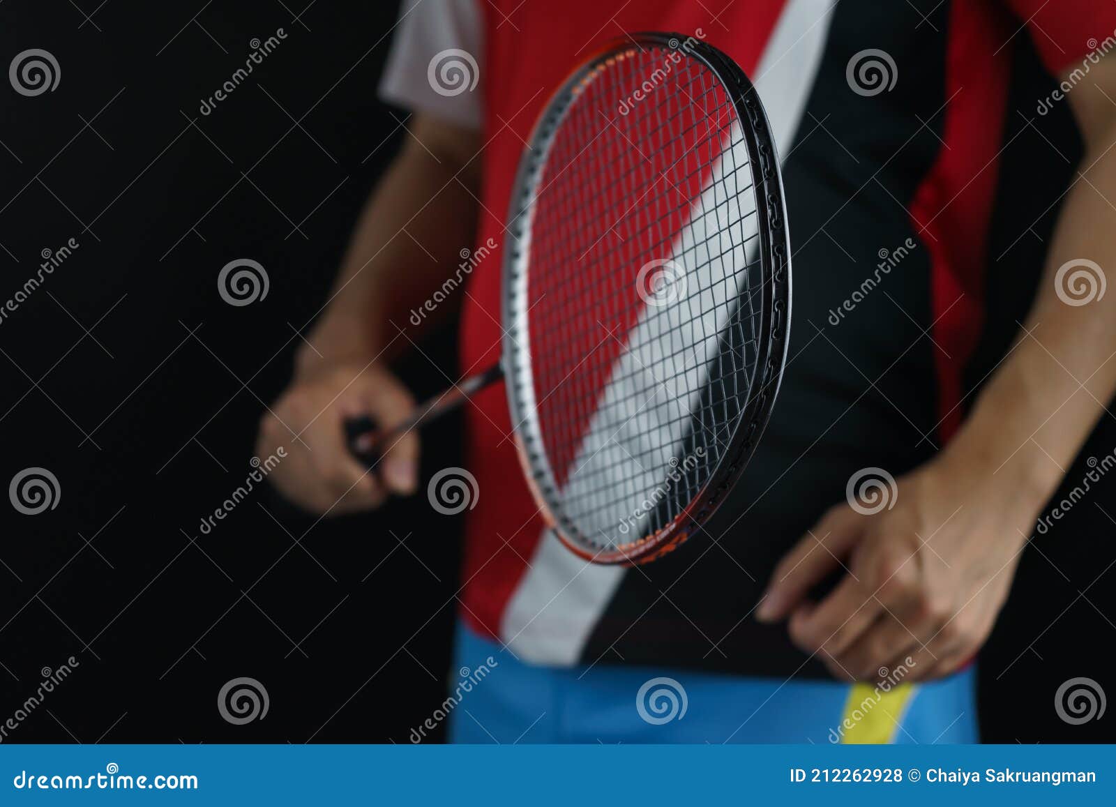 A Badminton Player Postures Receiving a Badminton Ball in a Competition ...