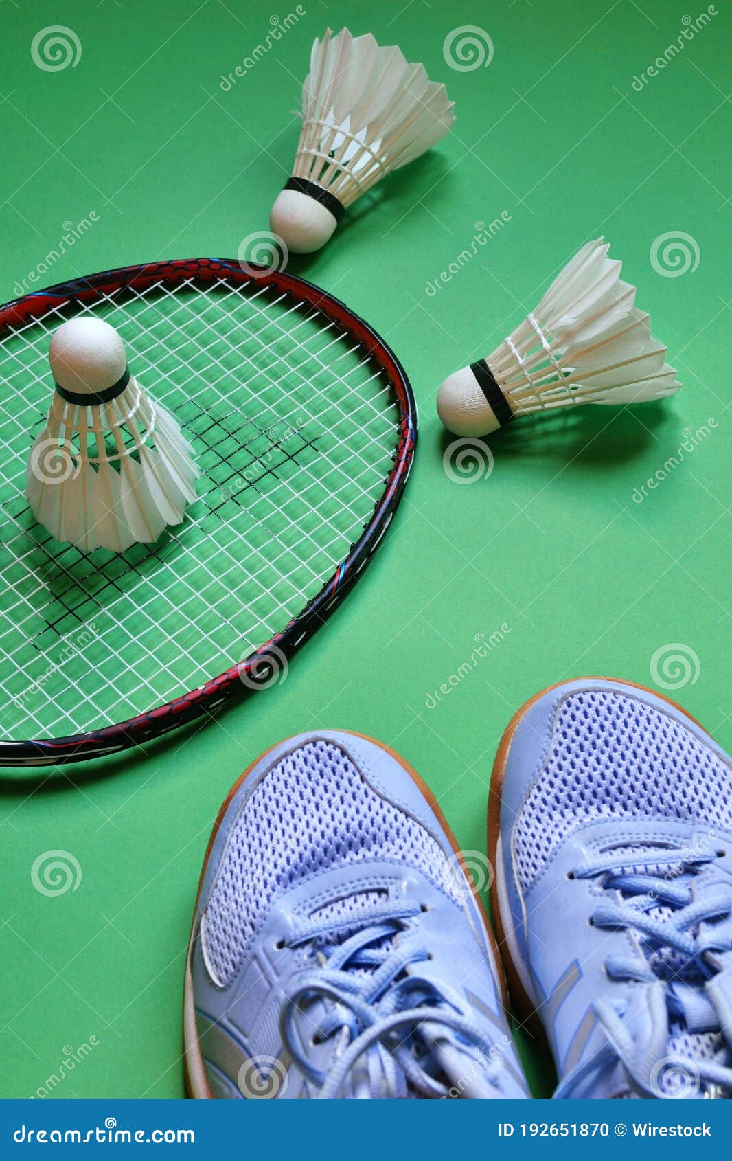 Badminton Racket and a Shuttlecock on the Ground with Blue Sneakers ...