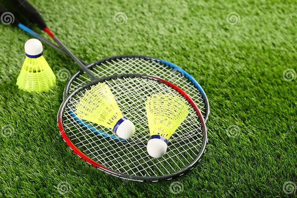 Badminton Rackets and Shuttlecocks on Green Grass Outdoors, Space for ...