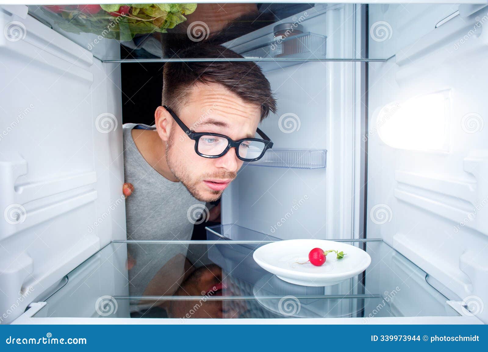 Baffled Man Looking Inside an almost Empty Fridge Stock Photo - Image ...