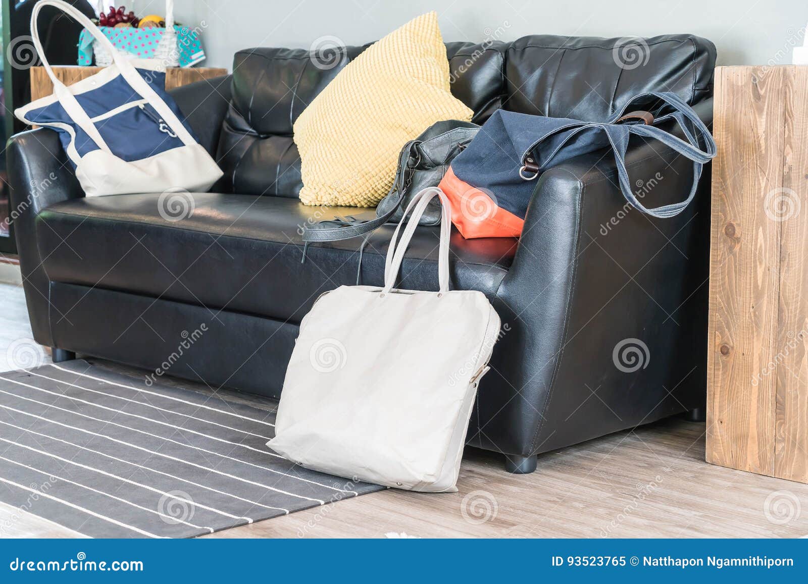 Bag on black leather sofa stock image. Image of fashion - 93523765
