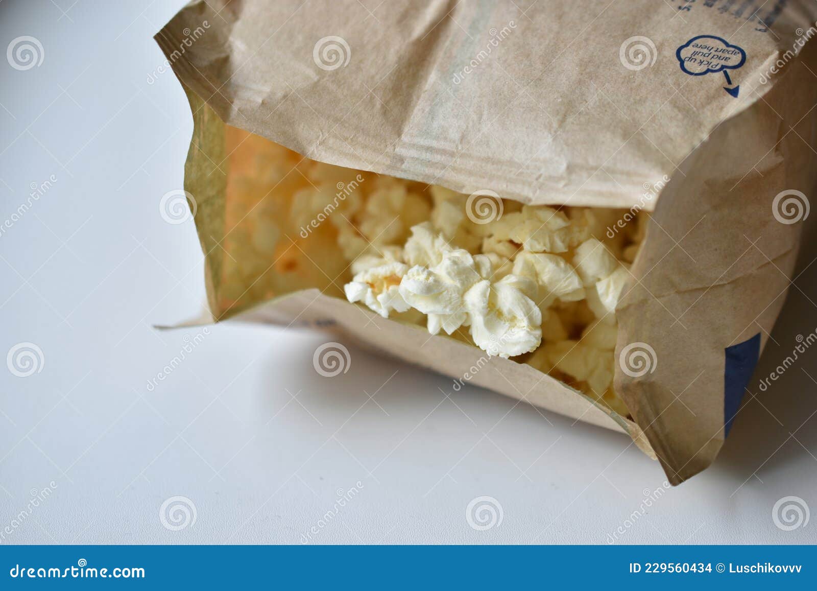 A Bag of Popcorn Open on a Plate in the Kitchen Stock Photo - Image of ...