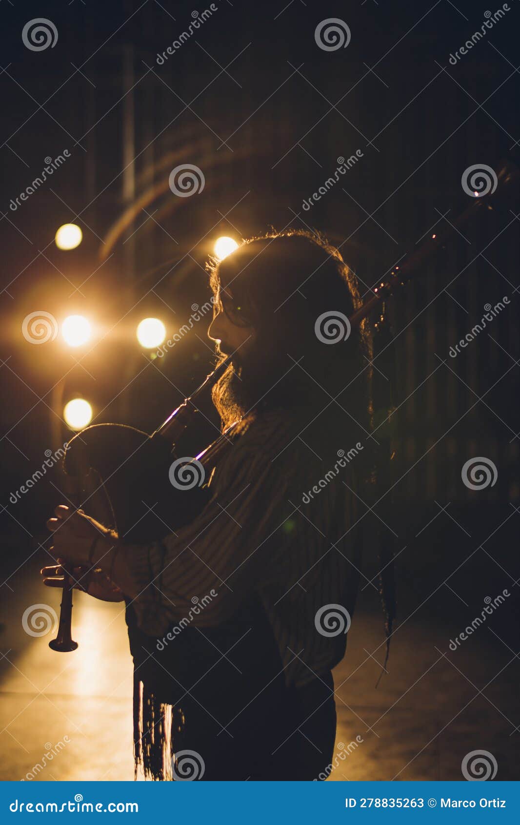 Bagpipe Player Playing His Instrument in an Auditorium with Stage ...