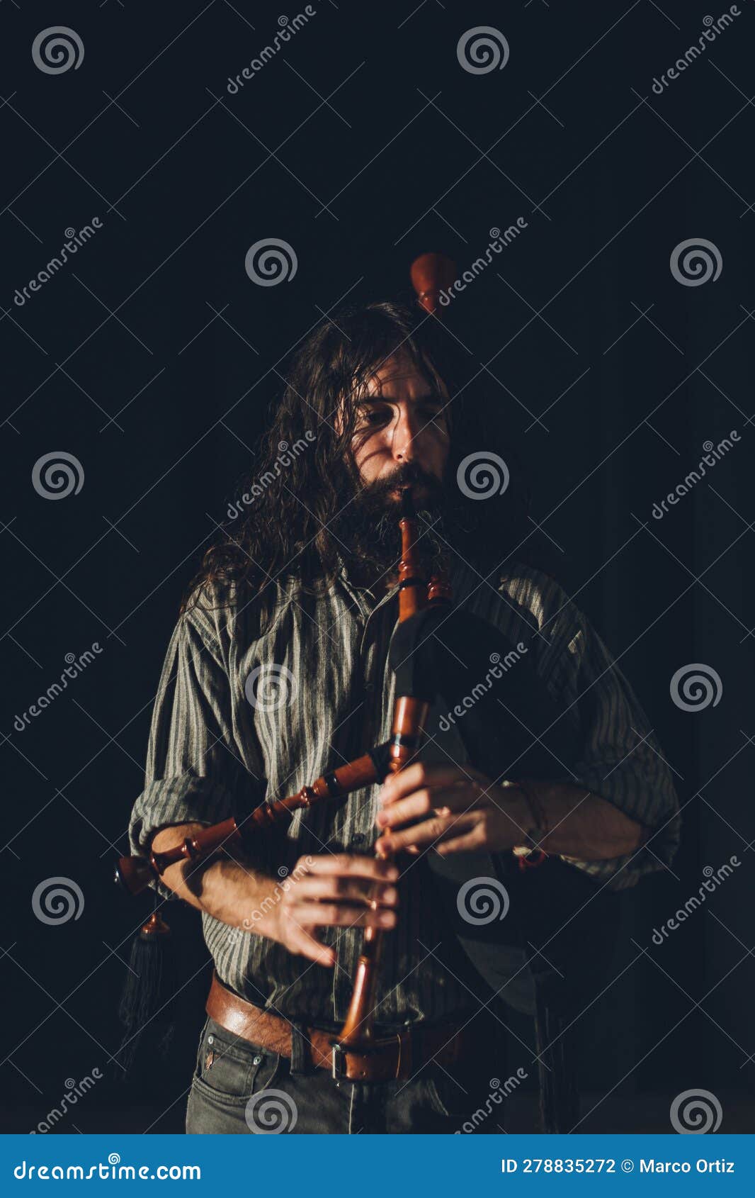 Bagpipe Player Playing His Instrument in an Auditorium with Stage ...
