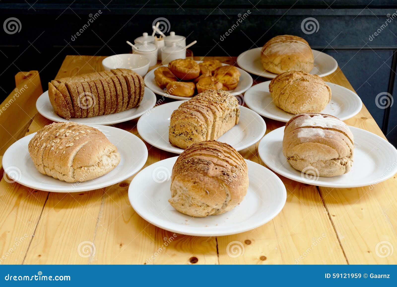 Baked Bread on White Plate and Wooden Table Stock Image - Image of ...