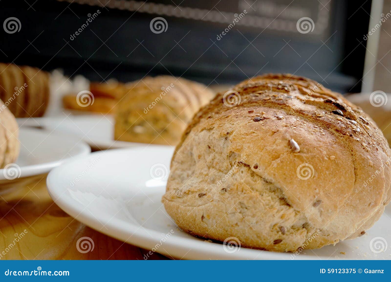 Baked Bread on White Plate and Wooden Table Stock Image - Image of ...