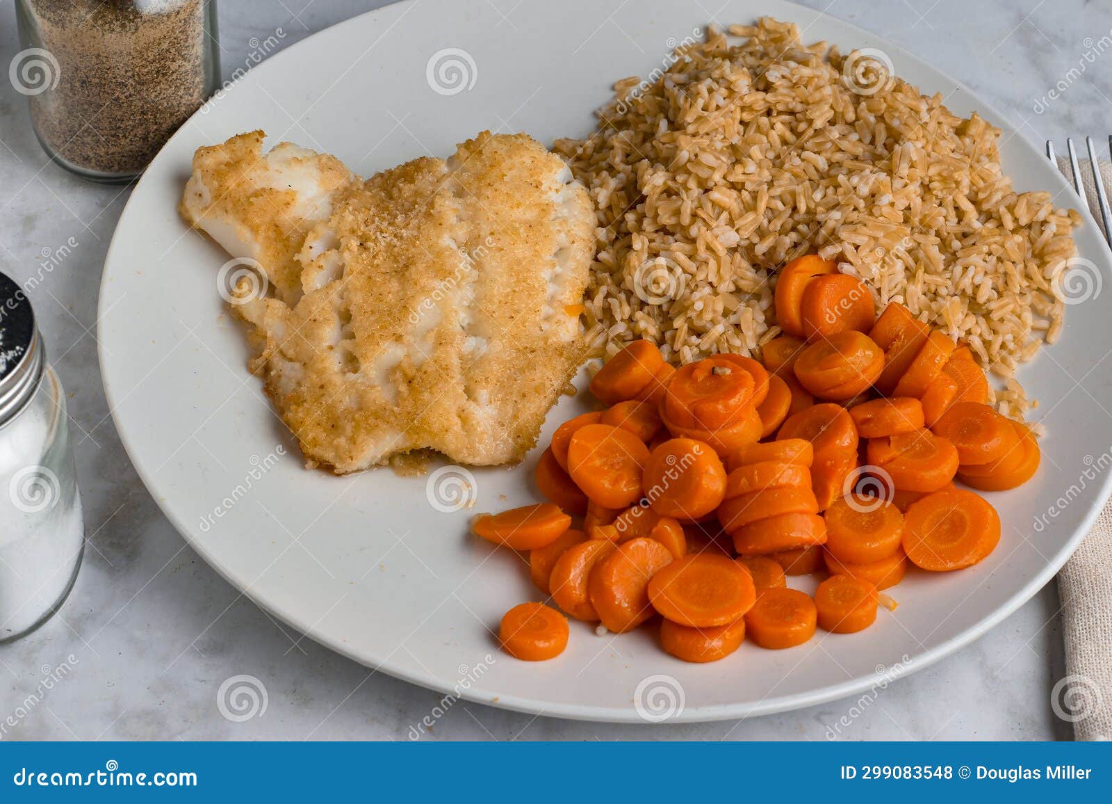 Baked Cod Served with Brown Rice and a Side of Carrots Stock Photo ...