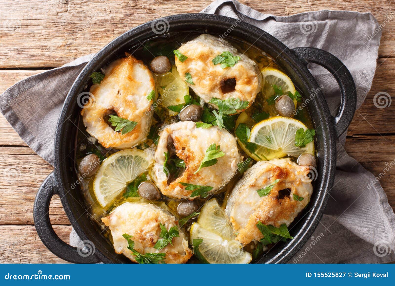 Baked Cod Steaks with Lemon and Olives Closeup in a Pan. Horizontal Top ...