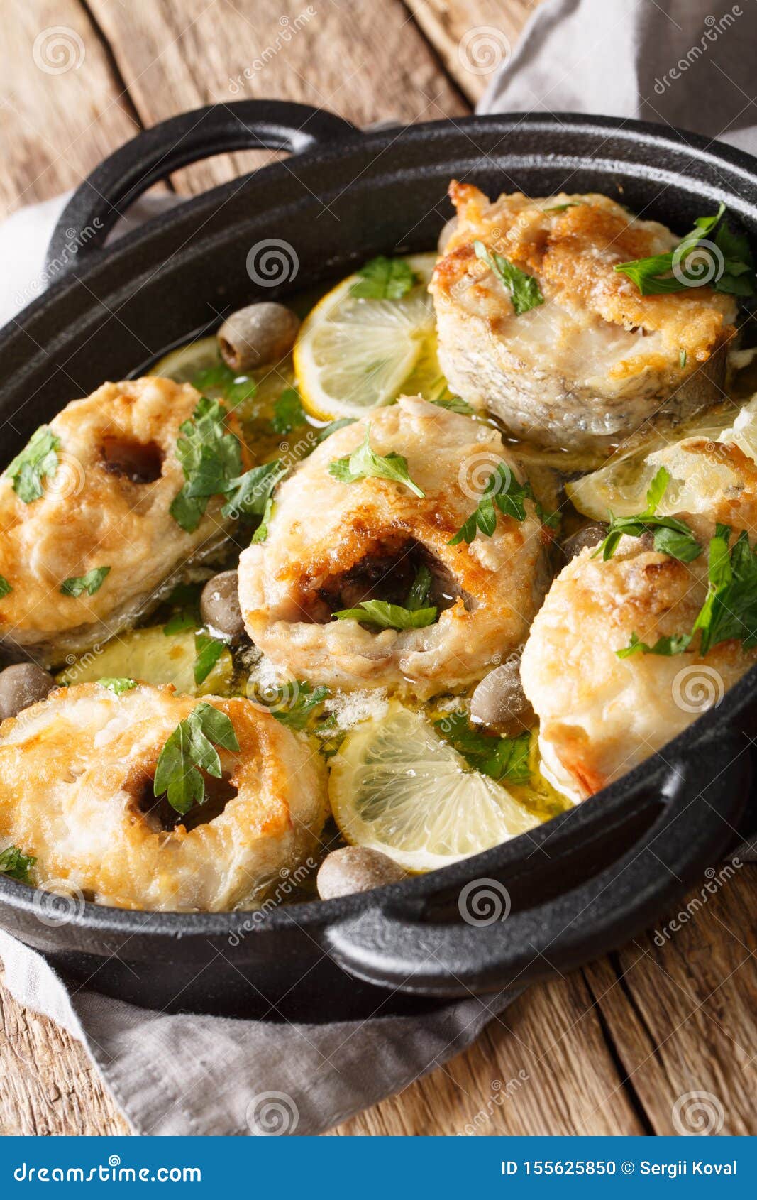 Baked Cod Steaks with Lemon and Olives Closeup in a Pan. Vertical Stock ...