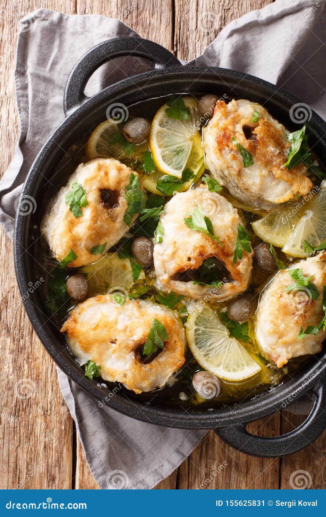 Baked Cod Steaks with Lemon and Olives Closeup in a Pan. Vertical Top ...