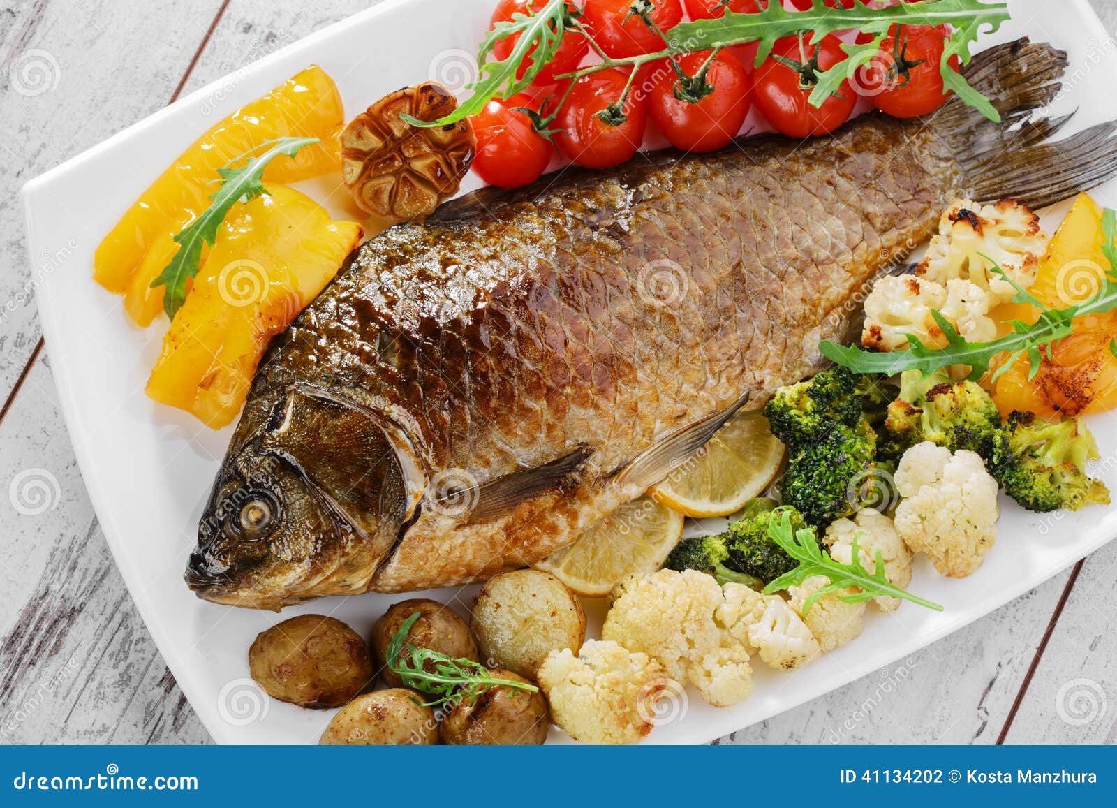 Baked fish with vegetables stock photo. Image of view - 41134202