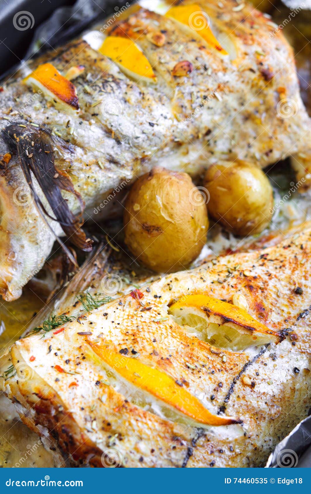 Baked Haddock with Lemon Slices and Small Potatoes Stock Image - Image ...