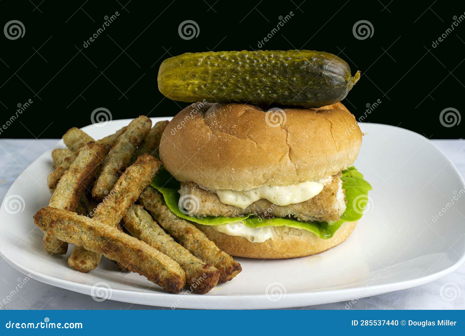 Baked Haddock Sandwich with Broccoli Fries and Pickle Stock Photo ...