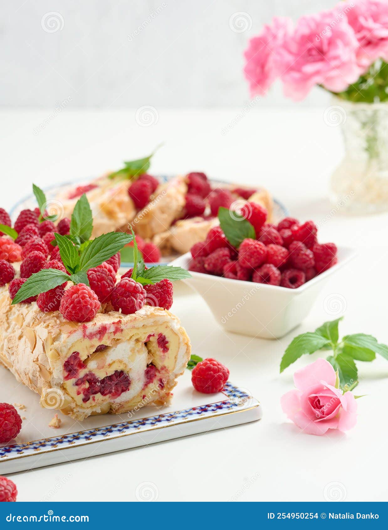 Baked Meringue Roll with Cream and Fresh Red Raspberry on a White Board ...