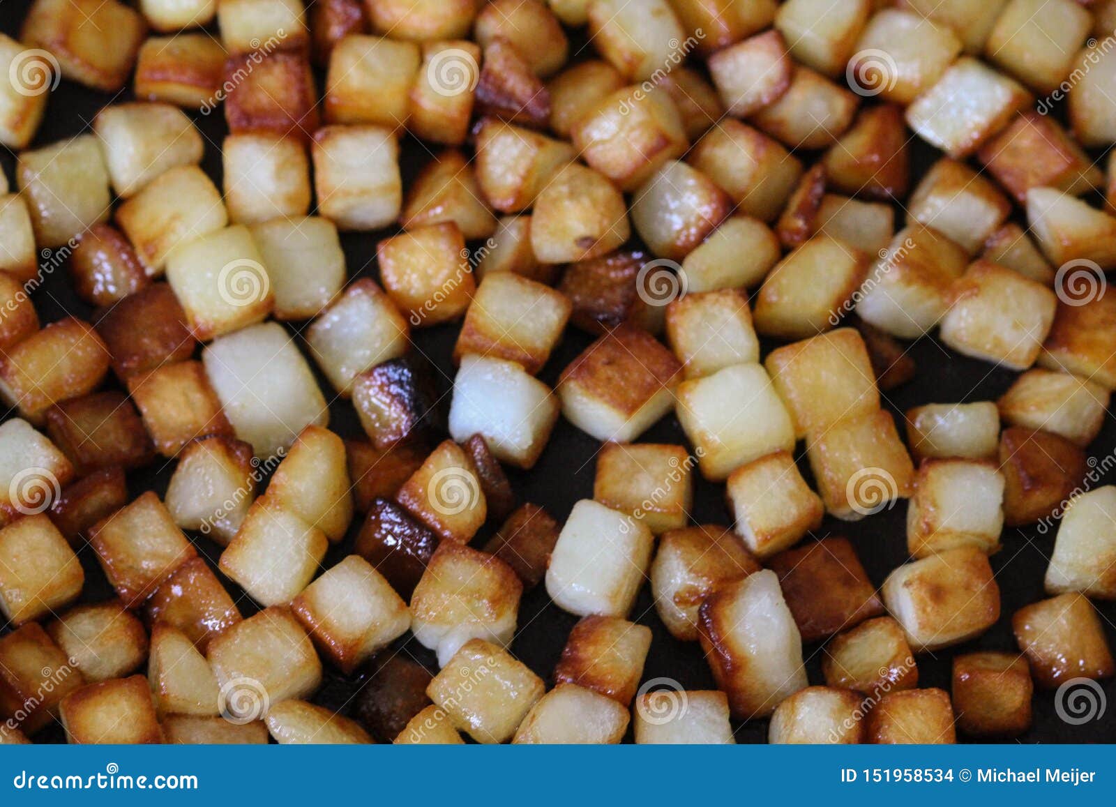 Baked Potato Cubes in Pan in Kitchen Stock Photo - Image of plate ...
