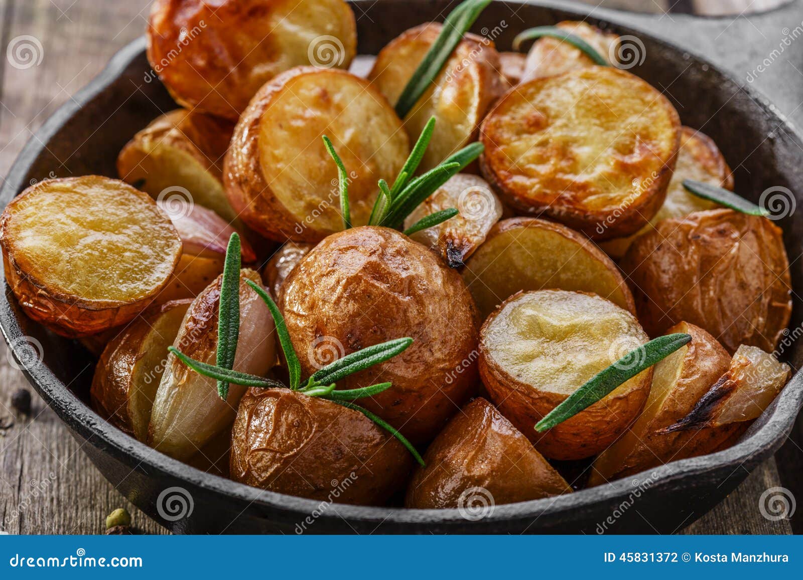 Baked potatoes in a pan stock photo. Image of rosemary - 45831372
