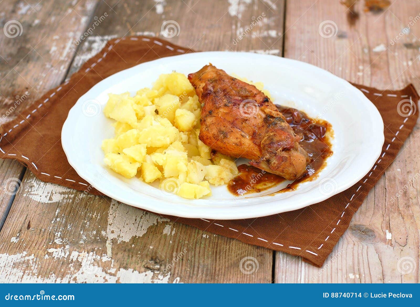 Baked Rabbit with Sauce and Mashed Potatoes on White Plate on Rustic ...