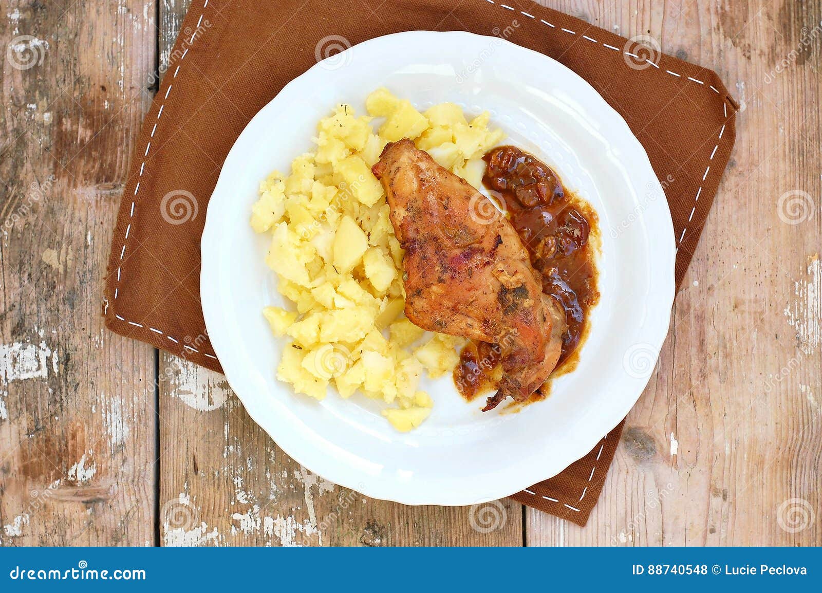 Baked Rabbit with Sauce and Mashed Potatoes on White Plate on Rustic ...