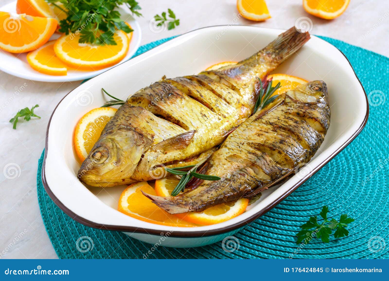 Baked Roach Fish with Vegetables and Oranges in a Ceramic Bowl. Diet ...