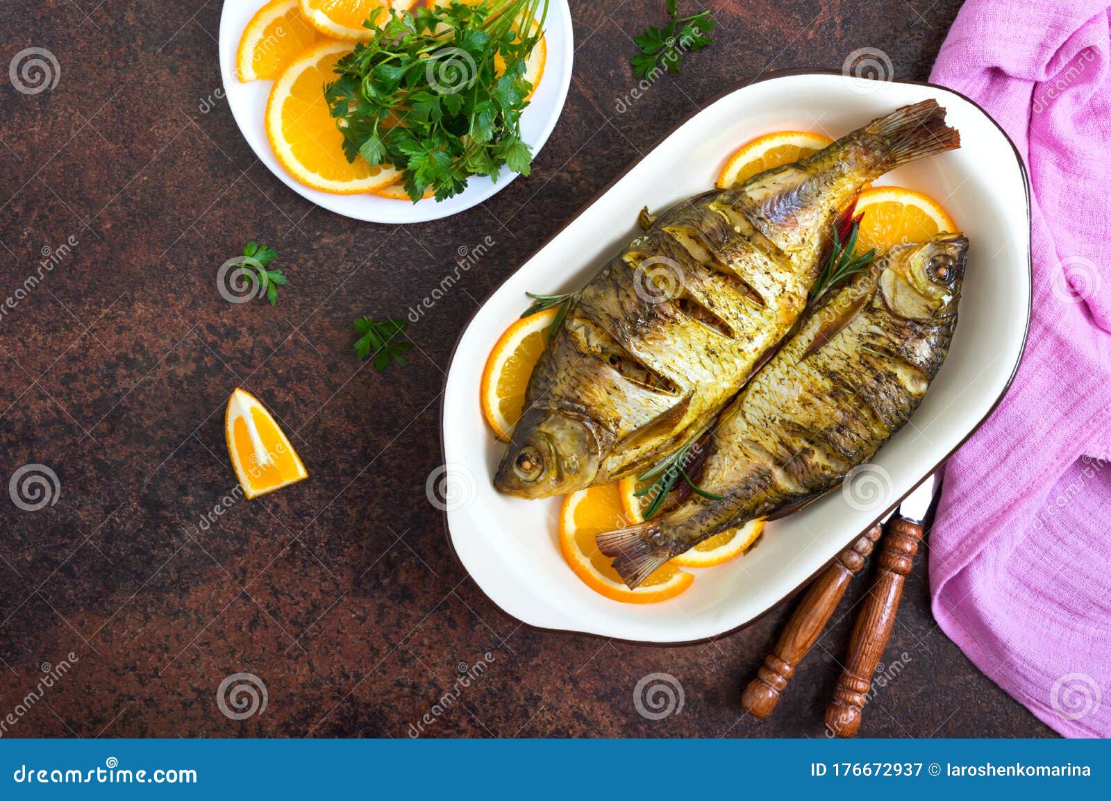 Baked Roach Fish with Vegetables and Oranges in a Ceramic Bowl. Top ...