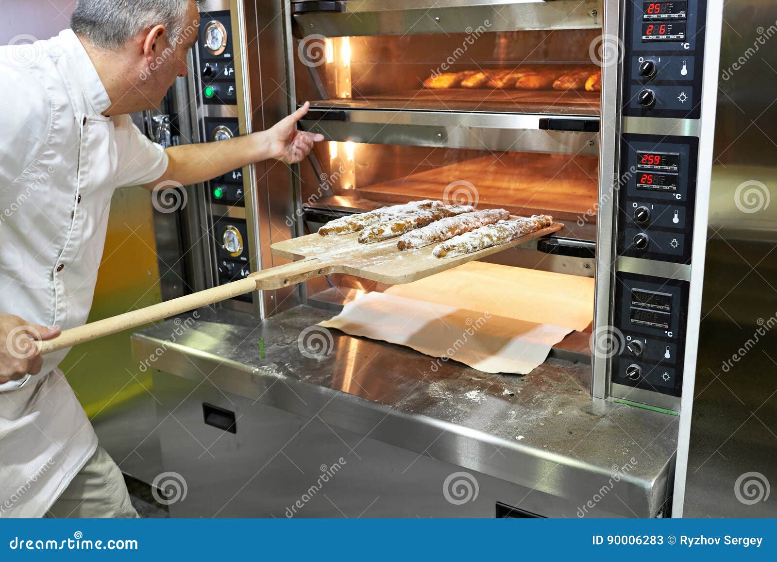 Baker bakes bread in oven stock image. Image of dough - 90006283