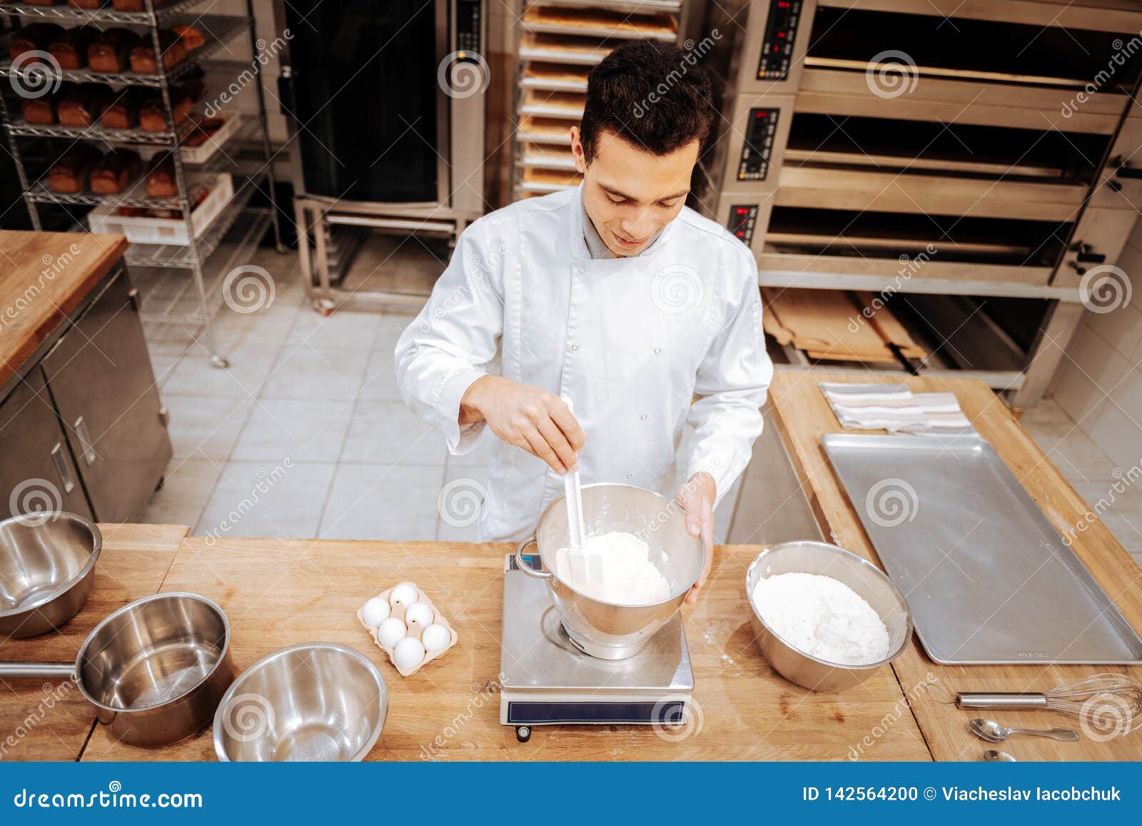 Baker Beating Whites and Putting Bowl on Kitchen Scales Stock Photo ...