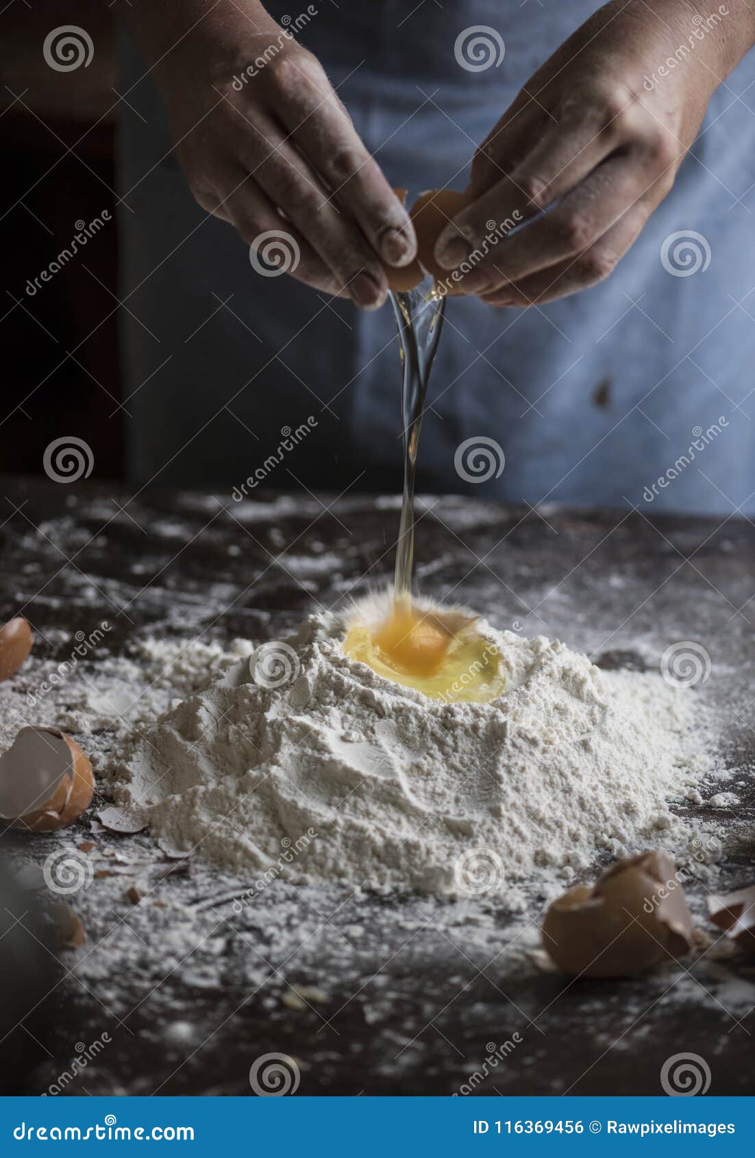 Baker Breaking an Egg into a Flour Mixture Stock Photo - Image of cook ...