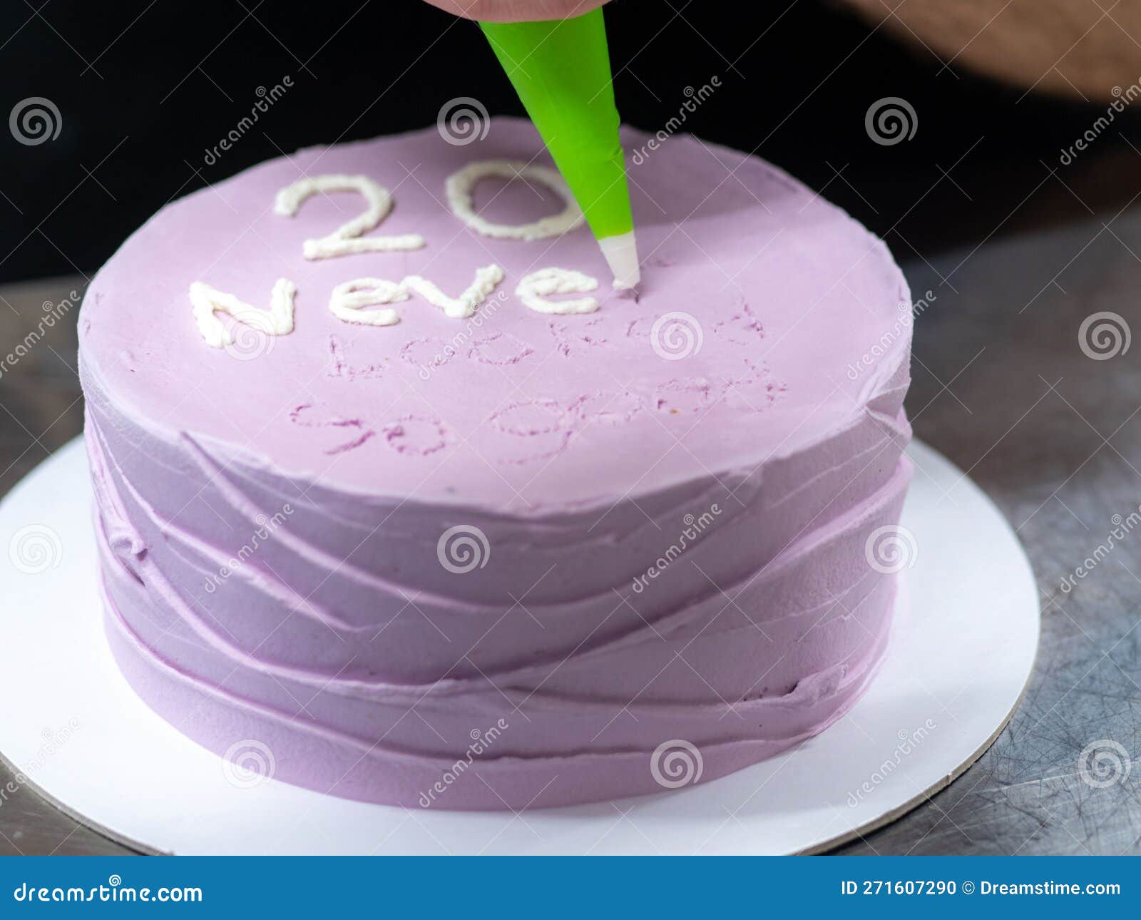 Baker Decorating a Beautiful Purple Cake in the Kitchen Stock Photo ...